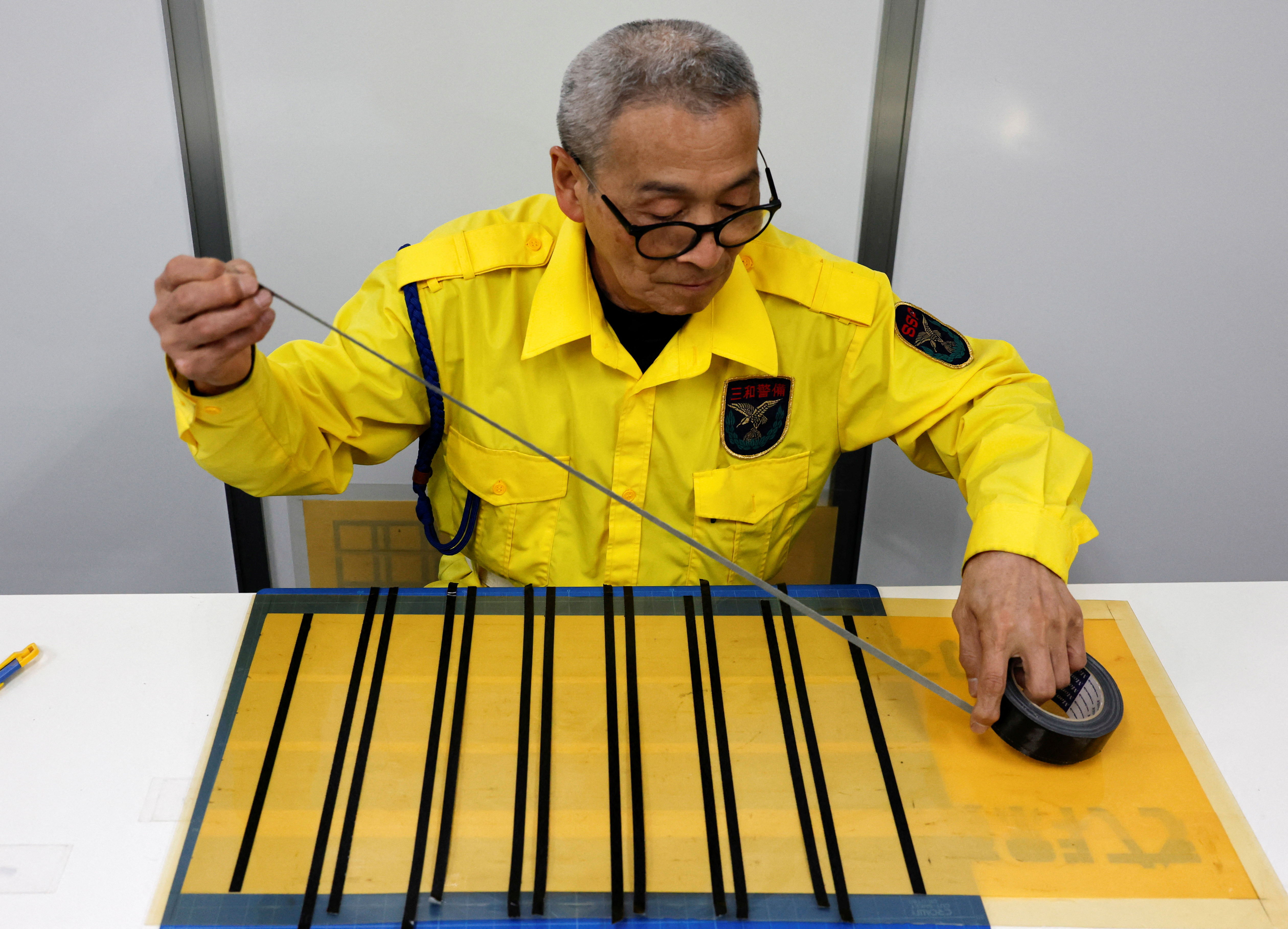 Japanese security guard finds fame as designer of duct tape signs ...